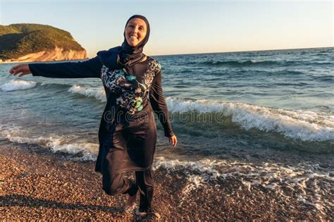 Woman In Hijab Standing On The Beach Looking At The Horizon Stock Image