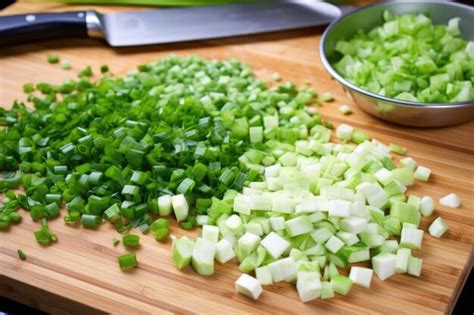 Premium Ai Image Adding Finely Chopped Scallions Into Wonton Soup