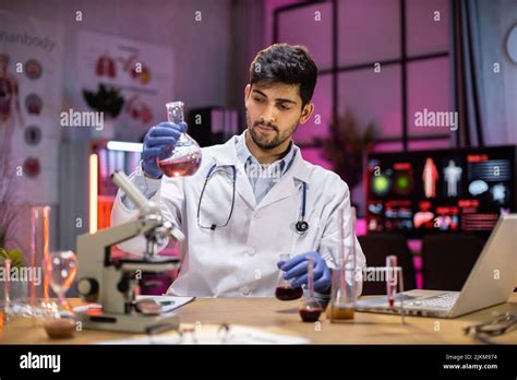 Yong Indian Male Scientist Working With Test Tubes Wearing Lab Coat