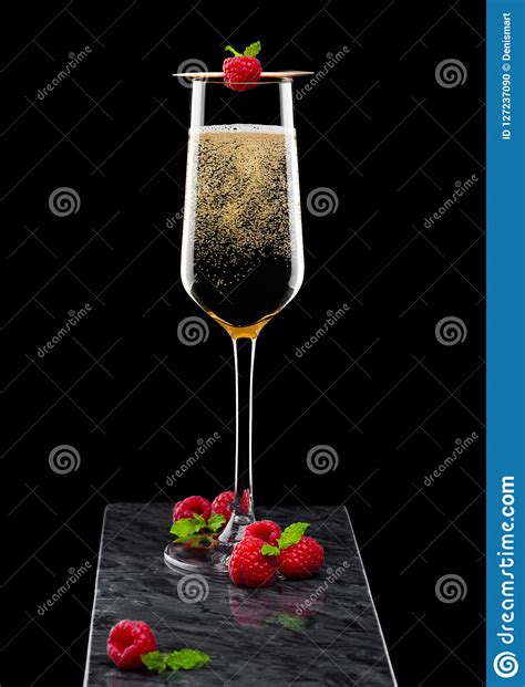 Elegant Glass Of Yellow Champagne With Raspberry And Fresh Berries With