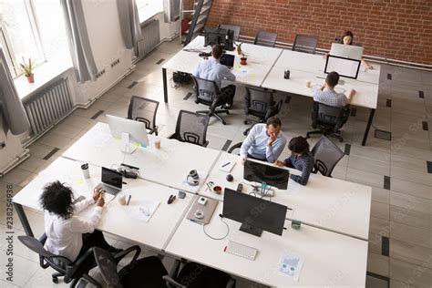 Employees Working Together In Modern Open Office Space Corporate Group