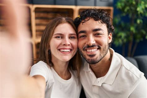 Man And Woman Hugging Each Other Make Selfie By The Smartphone At Home