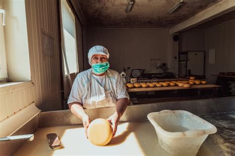A Woman In The Cheese Industry Woman Preparing Cheese For Further