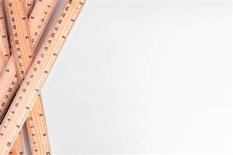 Premium Photo Close Up Of Metric And Imperial Rulers On White Background