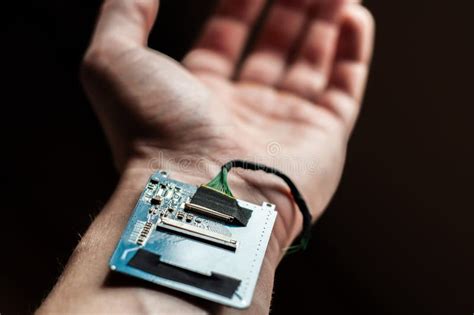 Implantation Of Chip Under The Human Skin Microchip Is Connected To The Girl Body Stock Photo