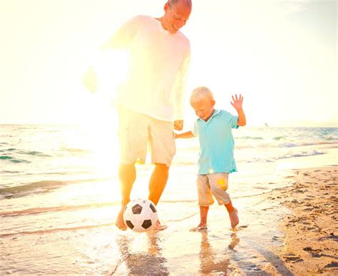 Dad And Son Playing Soccer By The Beach We Are Proud To Support Hope
