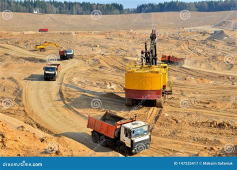 Quarry Excavator Loading Sand Or Into Dump Truck At Opencast Stock