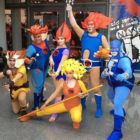 Group Of People Dressed In Costumes Posing For The Camera