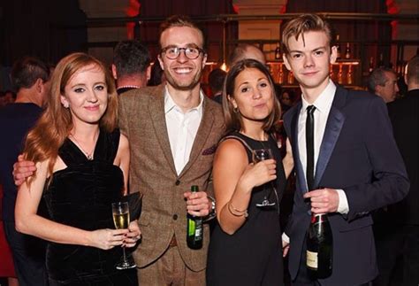 Four People Posing For The Camera At An Event