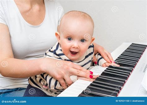 Mother Teaching Her Cute Baby To Play Piano Stock Photo Image Of