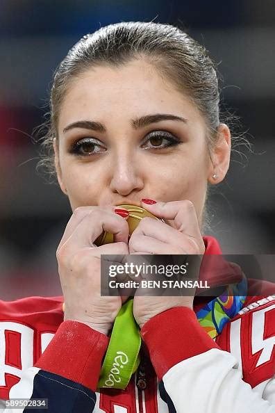 Russias Aliya Mustafina Celebrates With Her Gold Medal On The Podium