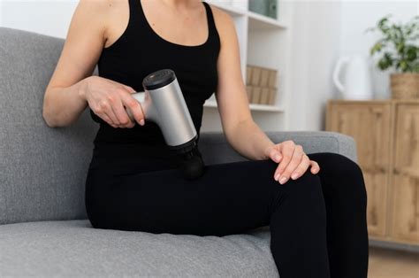 Free Photo Person Using Massage Gun