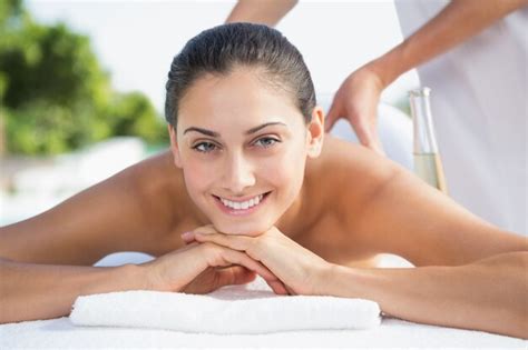 Premium Photo Smiling Brunette Enjoying A Massage Poolside