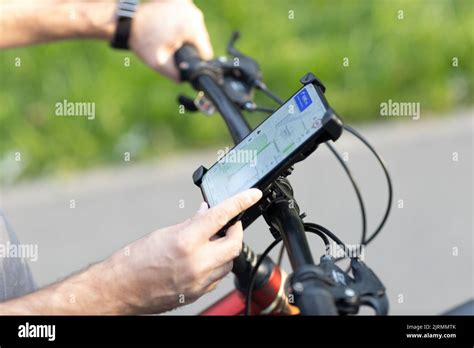 Man Planning Route Using Gps Navigation Application In Mobile Phone On His Bicycle Bike Stock