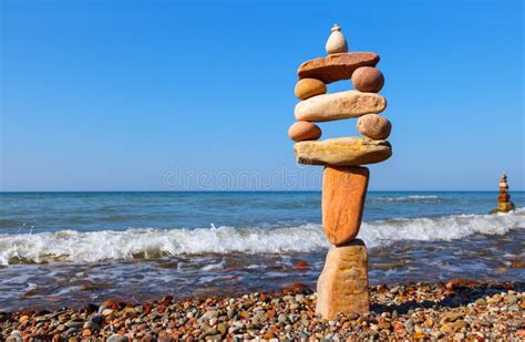 Rock Zen Pyramid Of Stones Of Different Shapes On A Background Of Blue