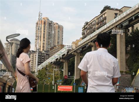 Visitors Watch A Monorail Train Of Chongqing Light Rail Line 2 Running