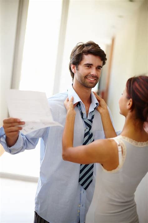 Helping Her Man Dress Handsome Man Reading While His Wife Dresses Him