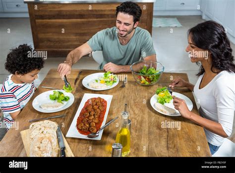 Happy family having lunch together Stock Photo - Alamy