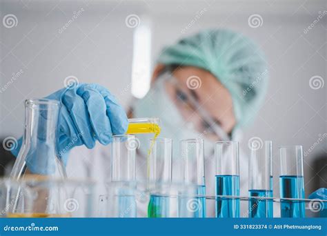 Female Researchers Are Experimenting With Pipette Dropping A Sample Into A Test Tube In An