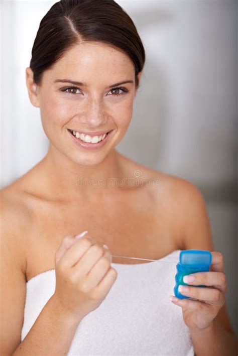 She Flosses Every Morning Portrait Of An Attractive Young Woman
