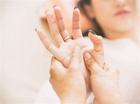 Woman Is Getting Her Hand Massaged By Masseur In Thai Spa Stock Photo