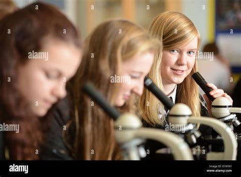 School Girls Using Microscopes During A Science Lesson At Pates Grammar School In Cheltenham
