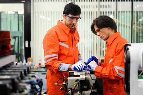 Engineers Working And Solving Problems On Machine At Industrial Plant Stock Image Image Of