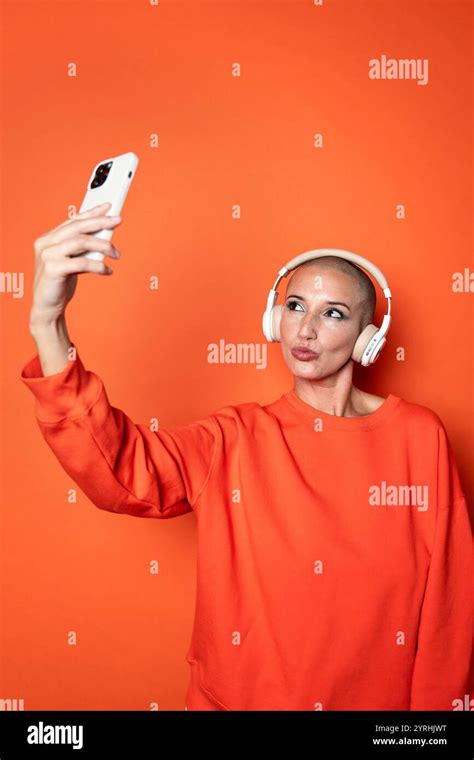A Adult Woman Clad In An Orange Sweatshirt Matches Boldly With The