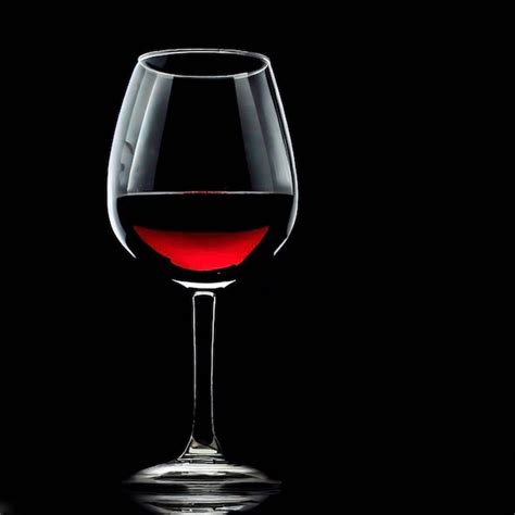 Premium Ai Image A Glass Of Red Wine On A Black Background