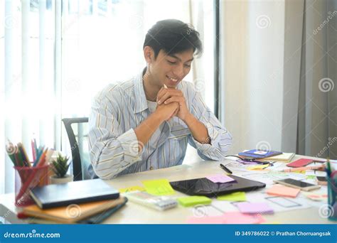 Smiling Male Ux Designer Working On App Design Ideas With Detailed