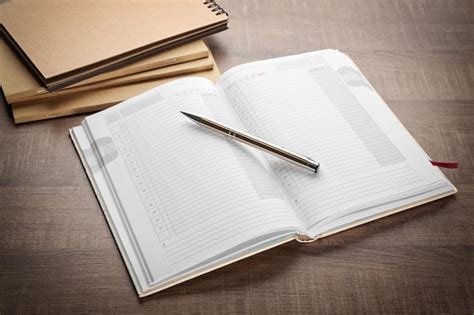 Premium Photo Notebook And Pen On Table