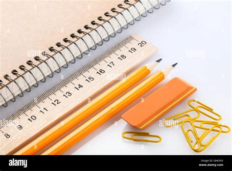 Notebook Eraser Ruler Pencil And Paperclips On White Background