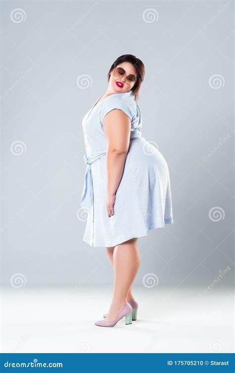 Plus Size Fashion Model In Striped Dress Fat Woman On Gray Background