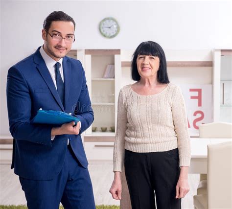 Male Real Estate Agent And Female Client In The Apartment Stock Image