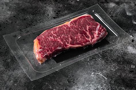 Daging Sapi Yang Dikemas Vakum Pada Latar Belakang Meja Batu Gelap