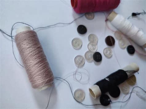 Premium Photo Buttons And Sewing Thread Isolated On White Background