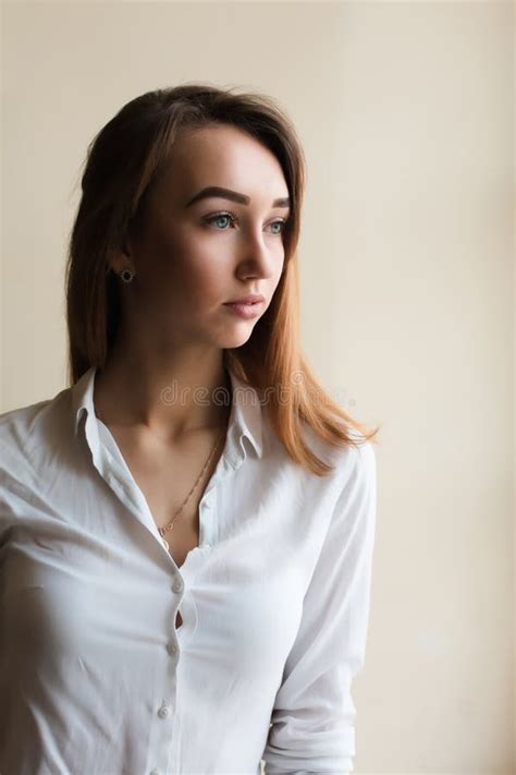 Romantic Young Brunette Model In White Shirt Posing At The Room Stock