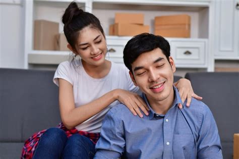 Premium Photo Smiling Woman Massaging Man While Sitting At Home