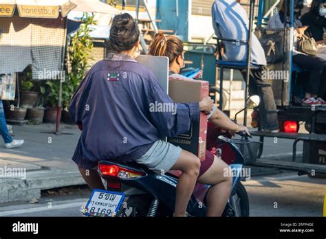 SAMUT PRAKAN THAILAND JAN 28 2023 Two Women Carry Cargo On A