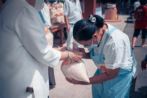 자선 활동가와 자원 봉사자들은 가난하고 굶주린 마을 사람들에게 쌀 마른 음식 및 돈을 기부하기 위해 왔습니다 난민에 대한 스톡