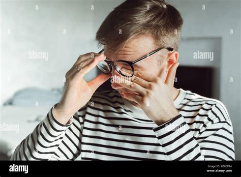 Tired Man Taking Off Glasses Rubbing Dry Irritated Eyes To Relieve Pain