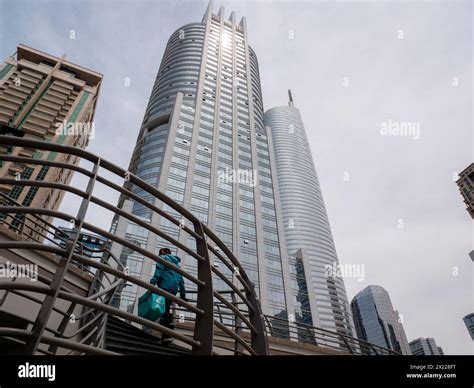 Deliveroo Delivery Worker Walking Up Stairs At Jlt Jumeirah Lake Towers