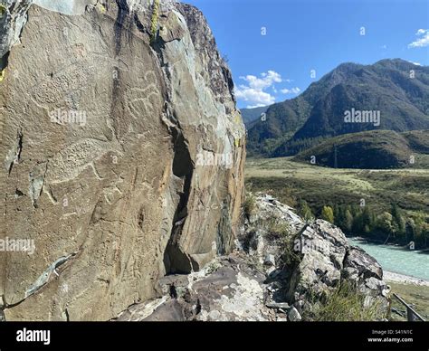 Rock Carvings Of Animals Of Ancient Man On A Rock In The Altai
