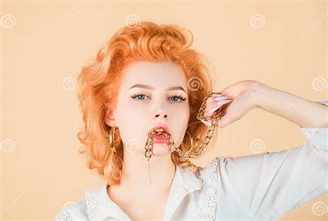 Redhead Woman Close Up Portrait With Golden Chain In Mouth Stock Image