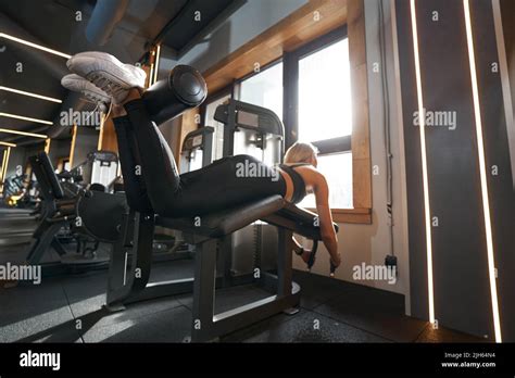 Woman Doing Hamstring Exercise In Fitness Club Stock Photo Alamy