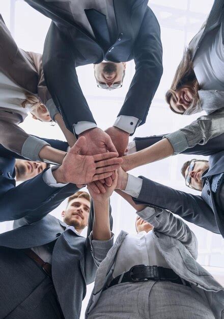 Premium Photo Bottom View Business Team Showing Unity With Their Hands Togetherthe Concept Of