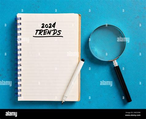 2024 Trends Handwritten On A Notebook With A Magnifier Popular Topics
