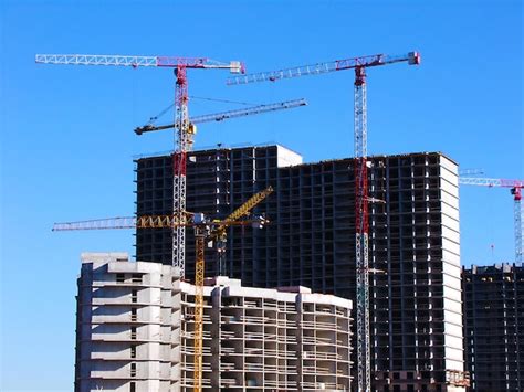 Premium Photo Low Angle View Of Cranes And Incomplete Buildings