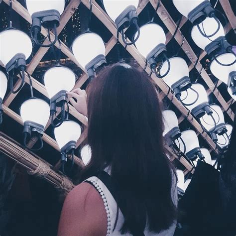Premium Photo Rear View Of Woman Touching Lighitng Equipment