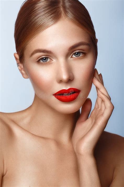 Beautiful Girl With Red Lips And Classic Makeup With Lipstick In Hand